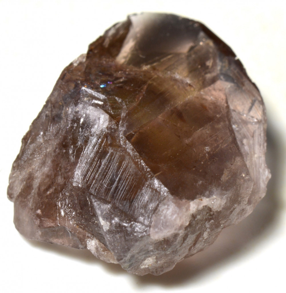 Axinite: Magnetism and Color